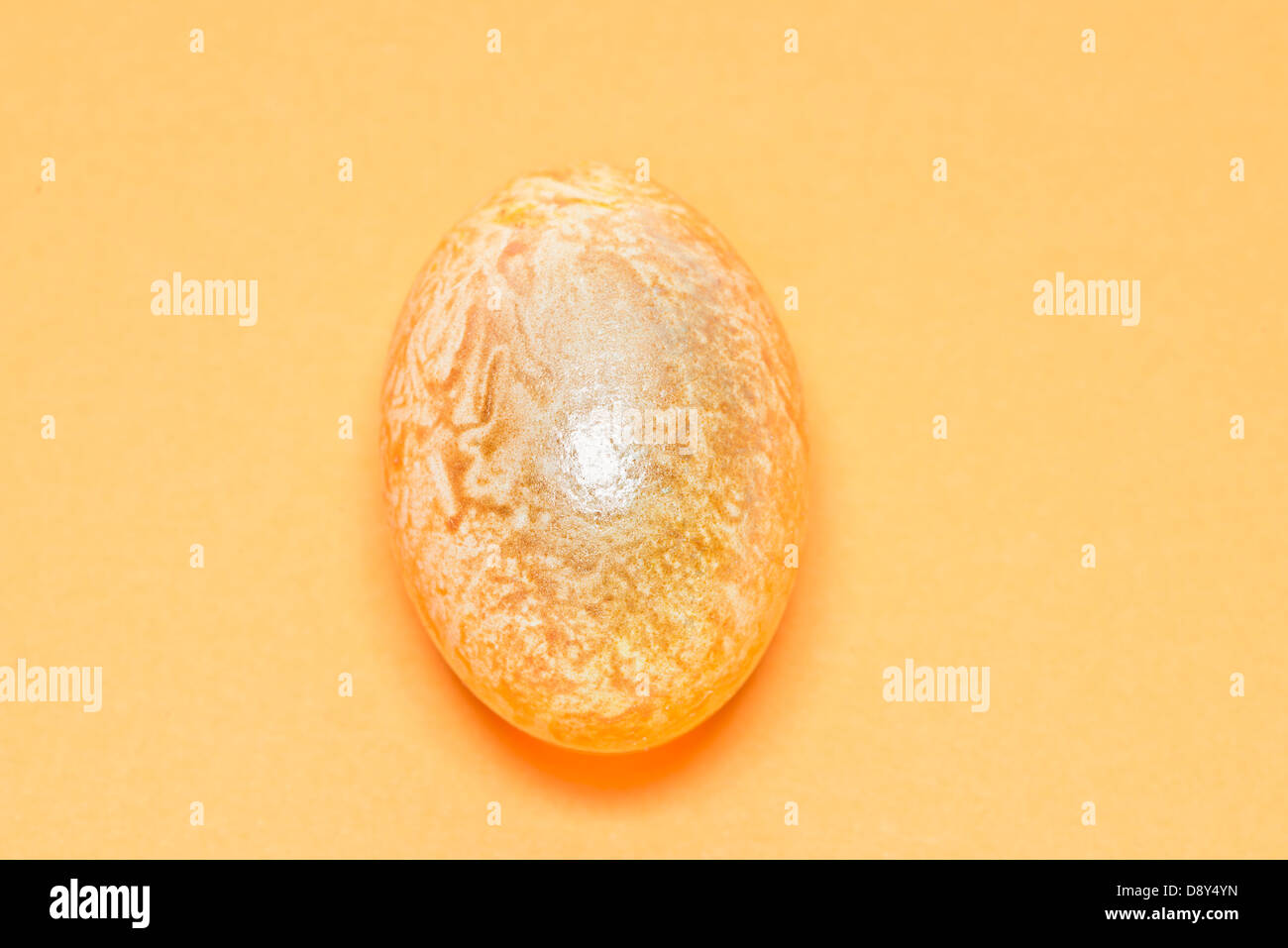 Golden egg, isolated on golden background Stock Photo - Alamy