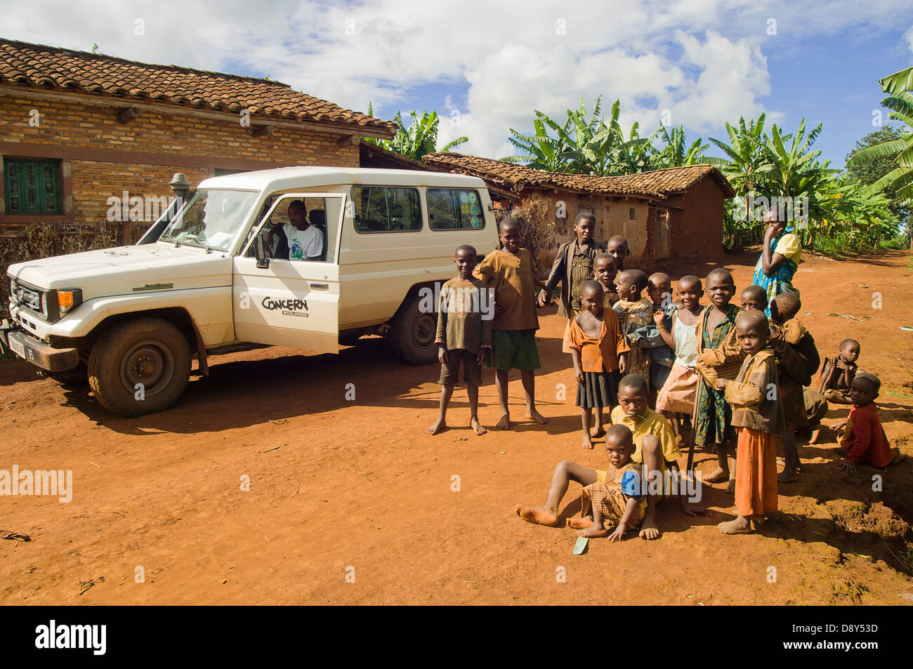 Group of children on road beside a development project vehicle African ...