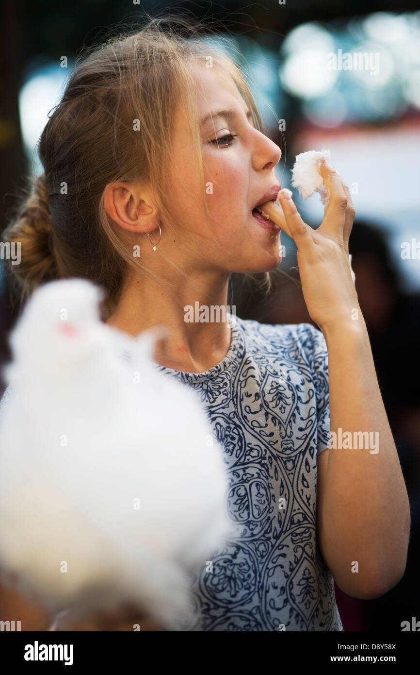 A girl eating candy floss Stock Photo - Alamy
