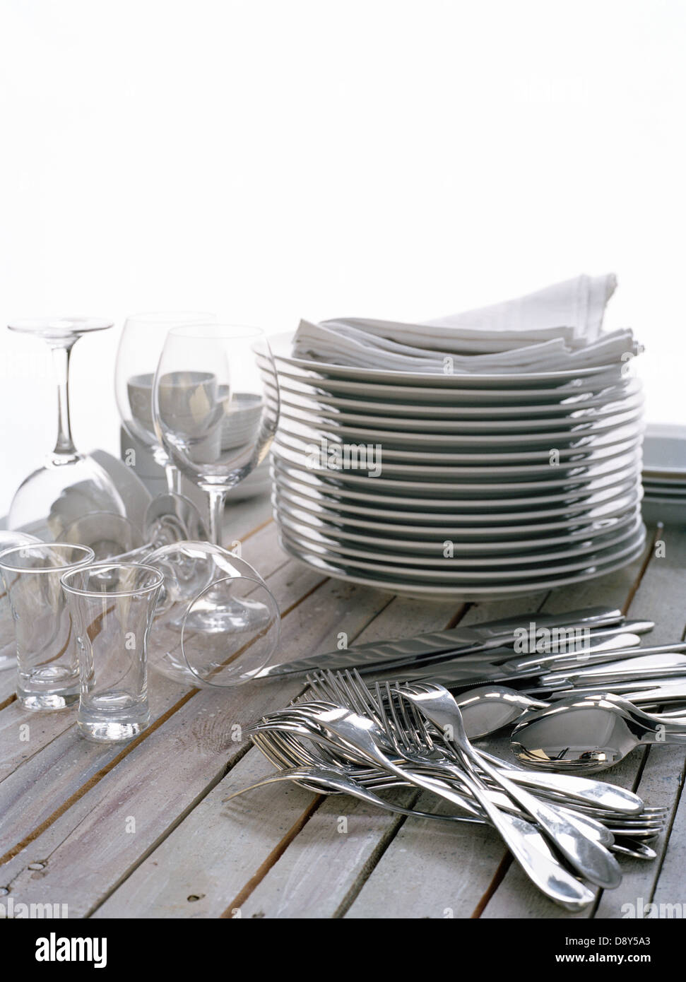 Glasses, plates and cutlery on a table Stock Photo - Alamy