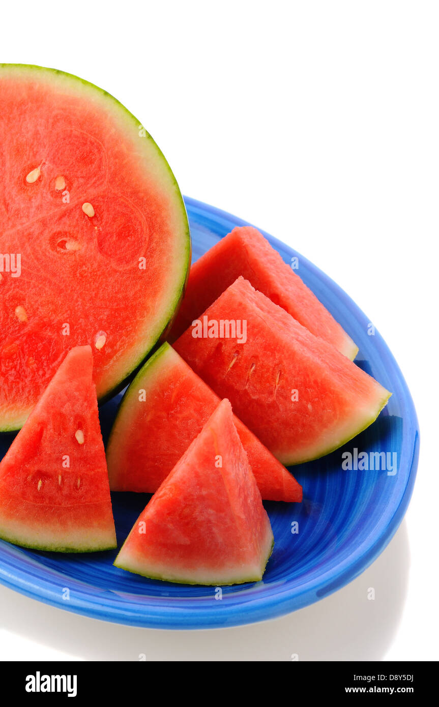 Closeup of a seedless watermelon on a blue platter. Half a melon ...