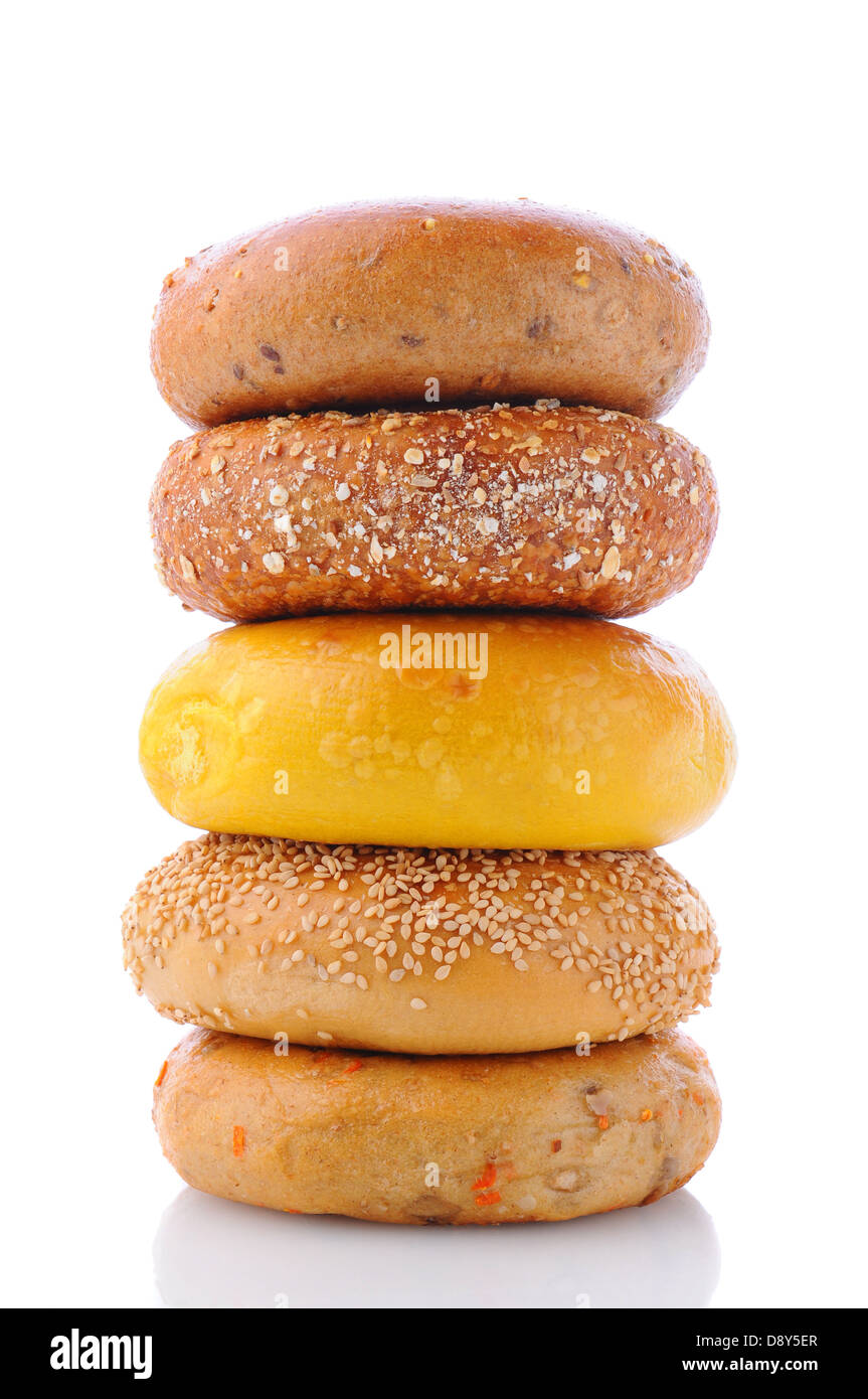 A stack of five different bagels on a white background with reflection ...