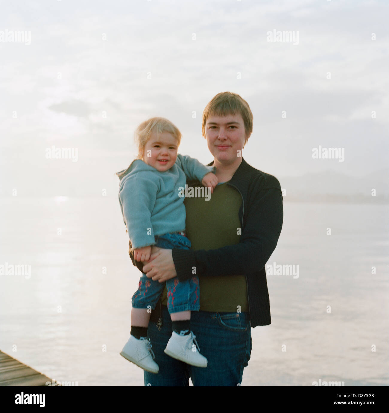 Mother carrying a child Stock Photo - Alamy