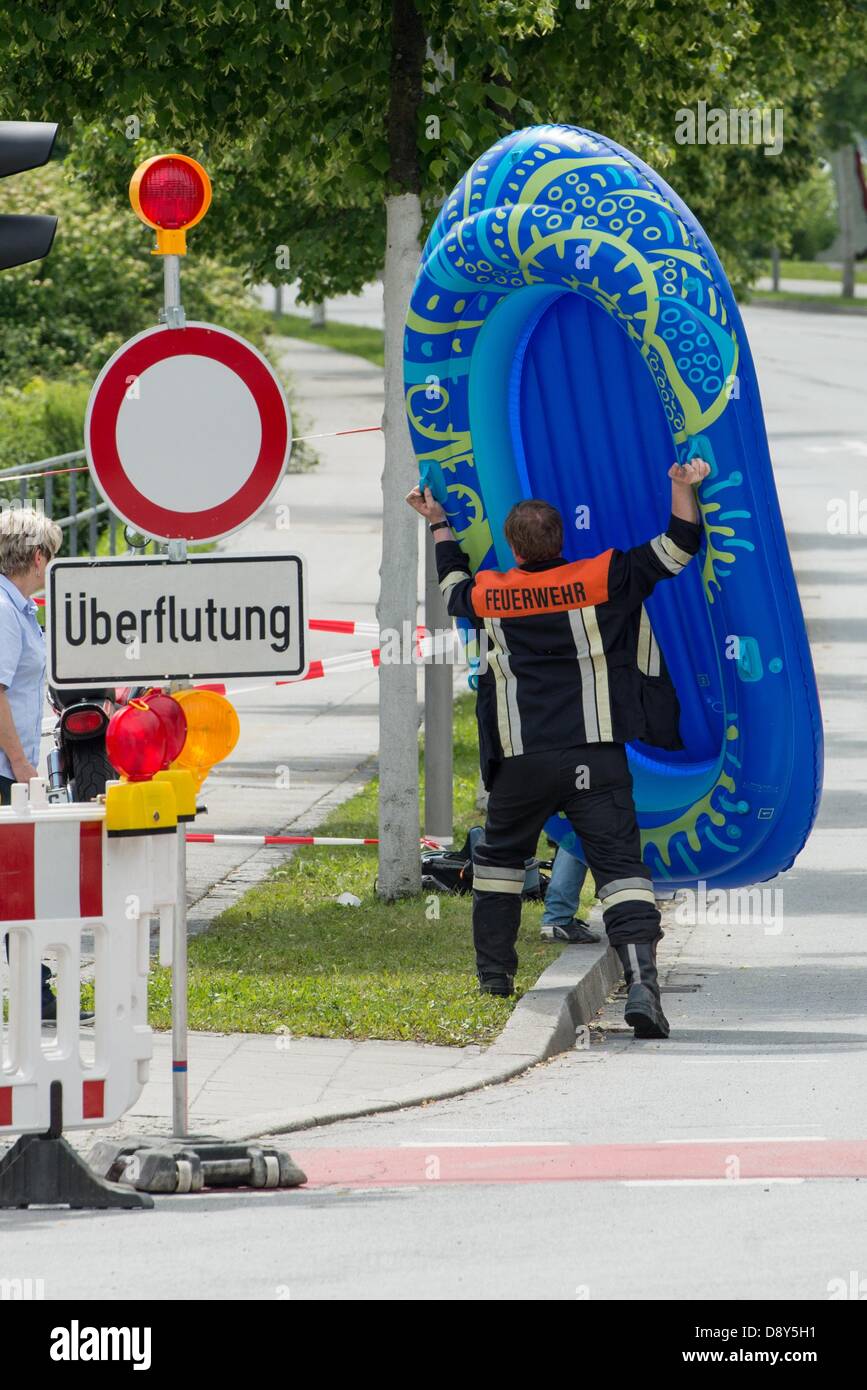A fireman carries an inflatable raft along the Danube in the ...
