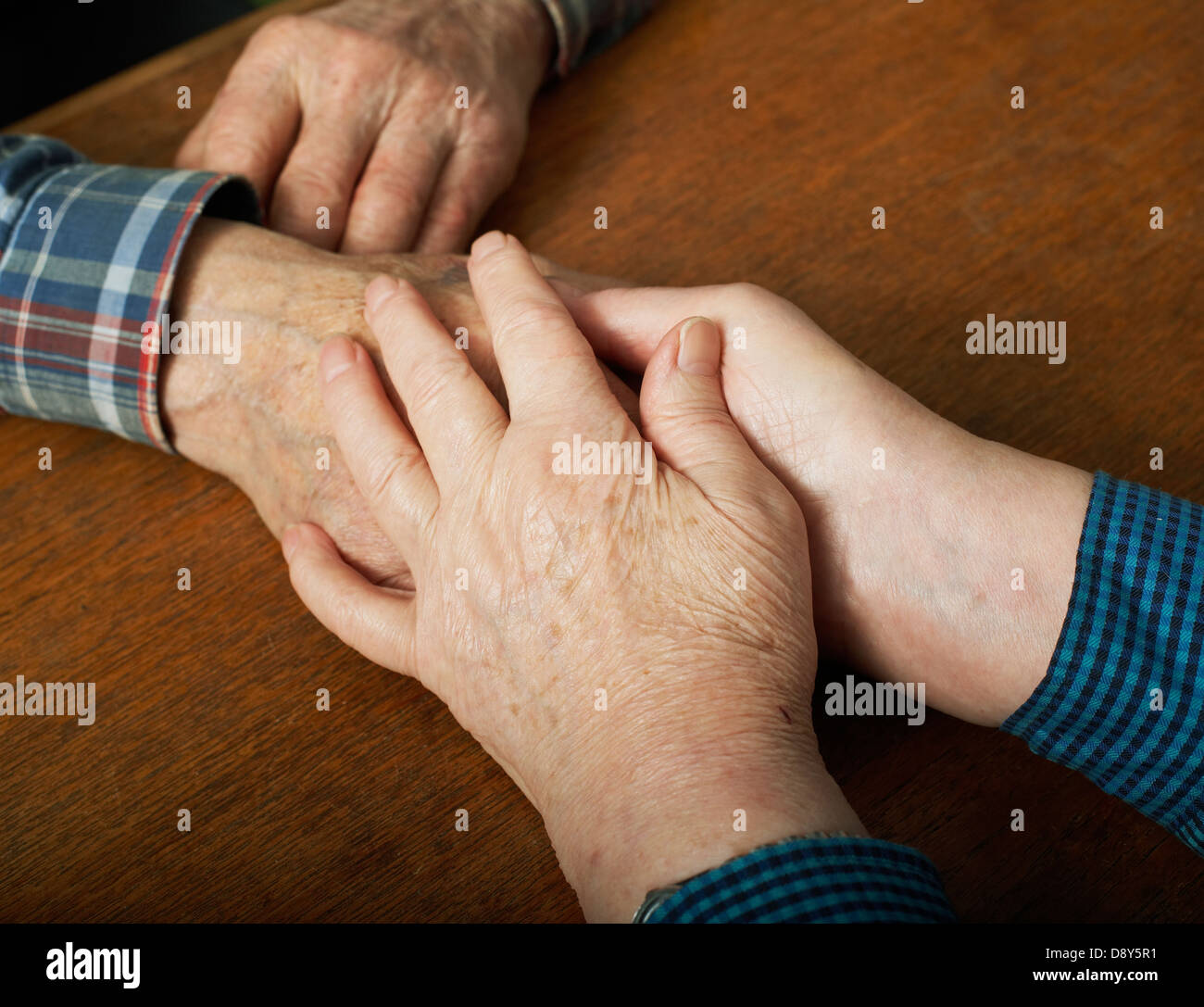 Close-up on two hands on a table Stock Photo - Alamy