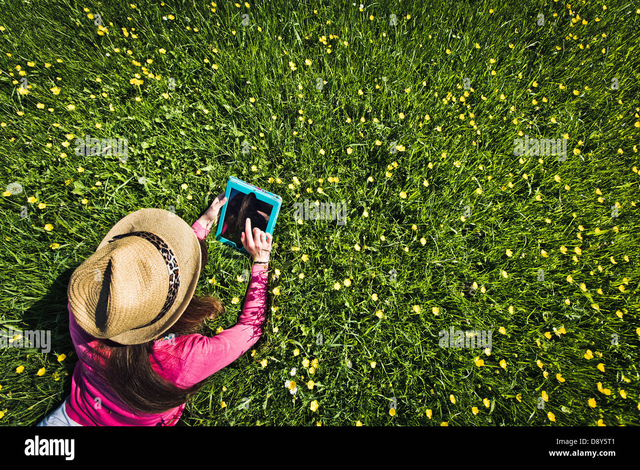 Teenage girl in field with ipad Stock Photo - Alamy