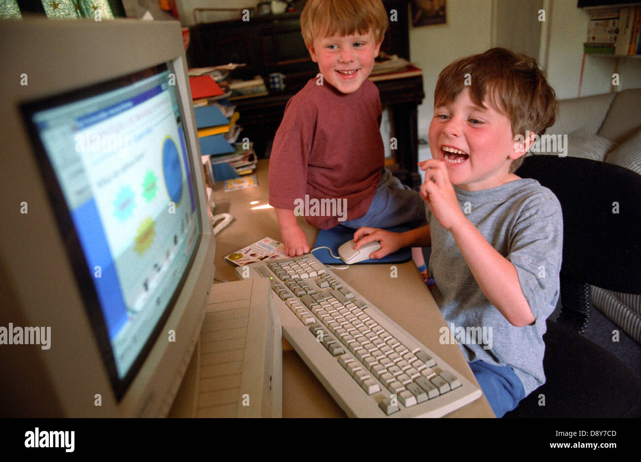 Children having fun playing on a computer. EDITORIAL USE ONLY Stock ...