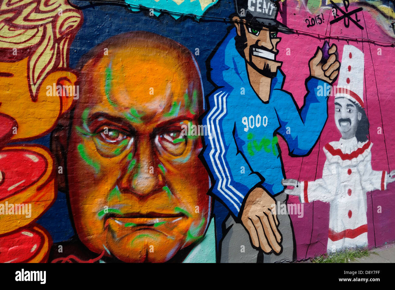 Colourful graffiti on wall in alley showing the mayor of Ghent, Daniel ...
