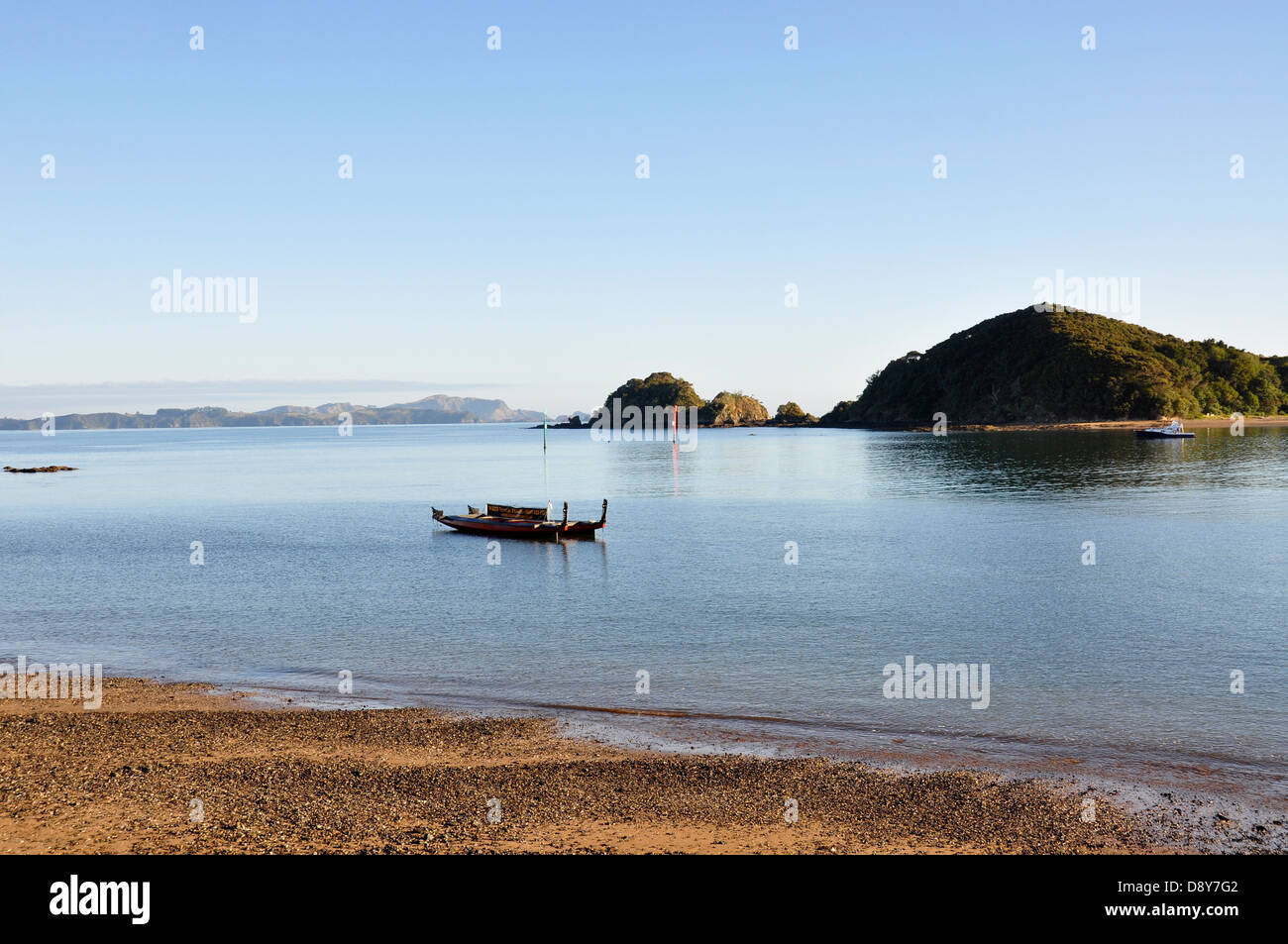 boat in bay New Zealand with hills island sandy beach Stock Photo - Alamy
