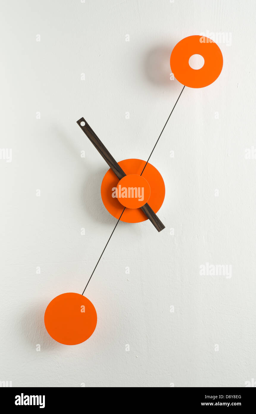 Modern clock hanging on a wall Stock Photo - Alamy