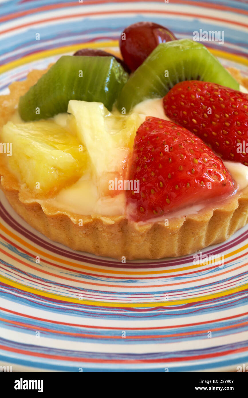 mixed fruit tart set on striped plate Stock Photo - Alamy