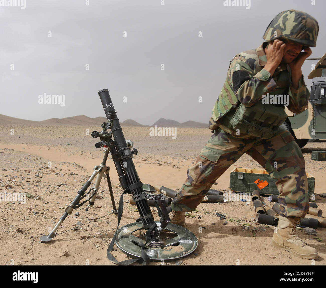 An Afghan National Army commando with Special Operations Kandak fires a ...