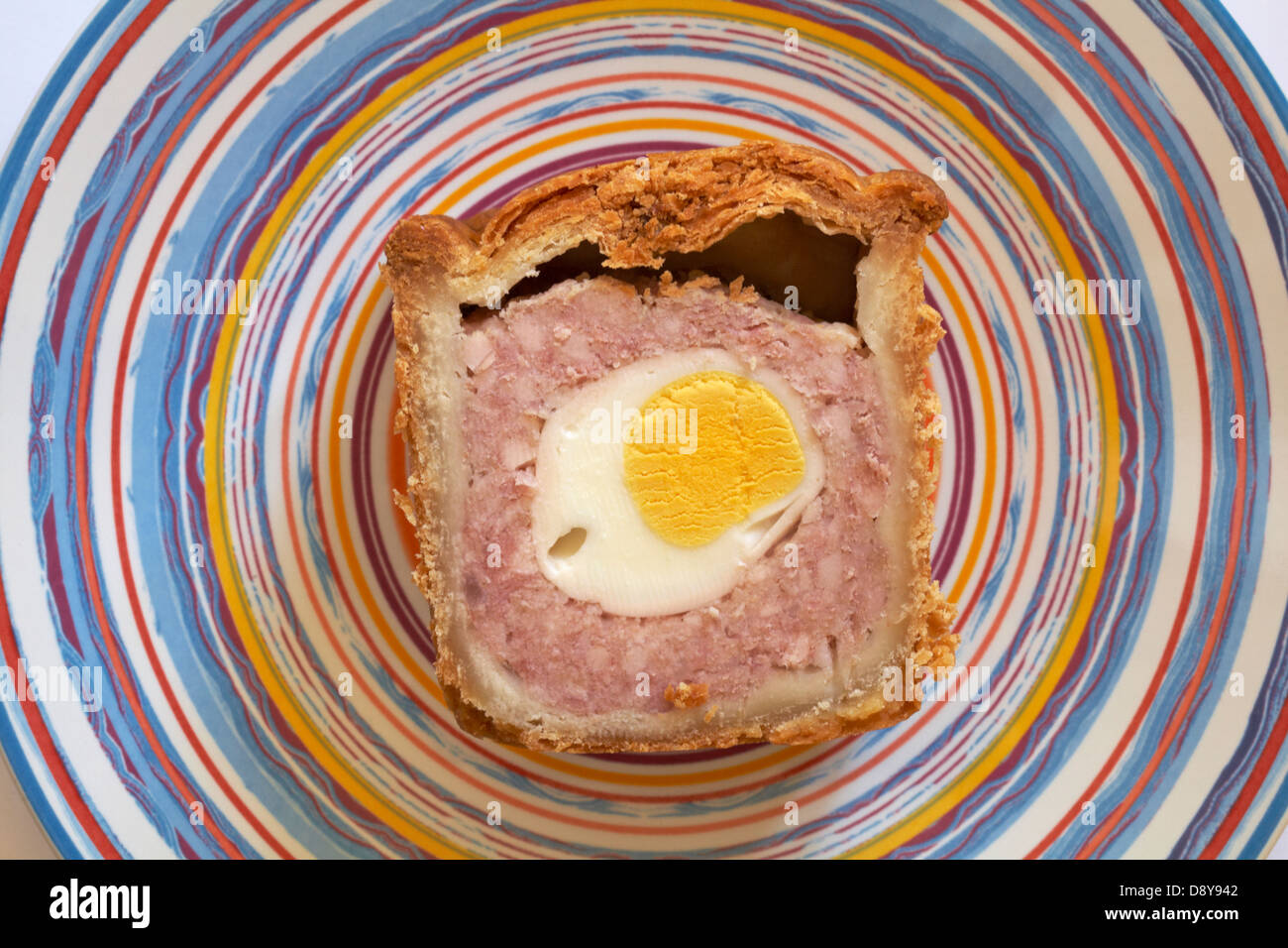 slice of pork pie with egg in on striped plate Stock Photo - Alamy