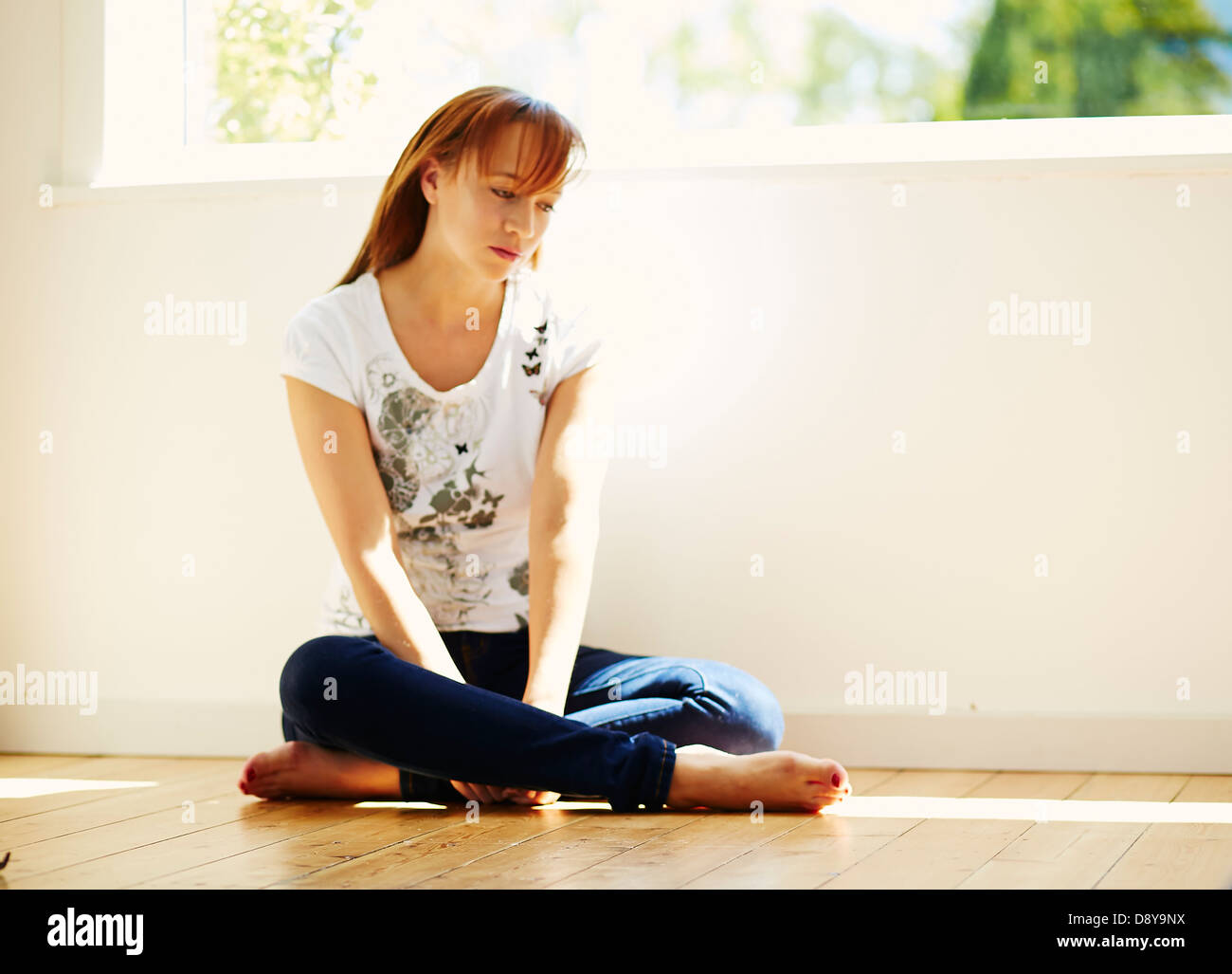 Girl sat alone Stock Photo - Alamy