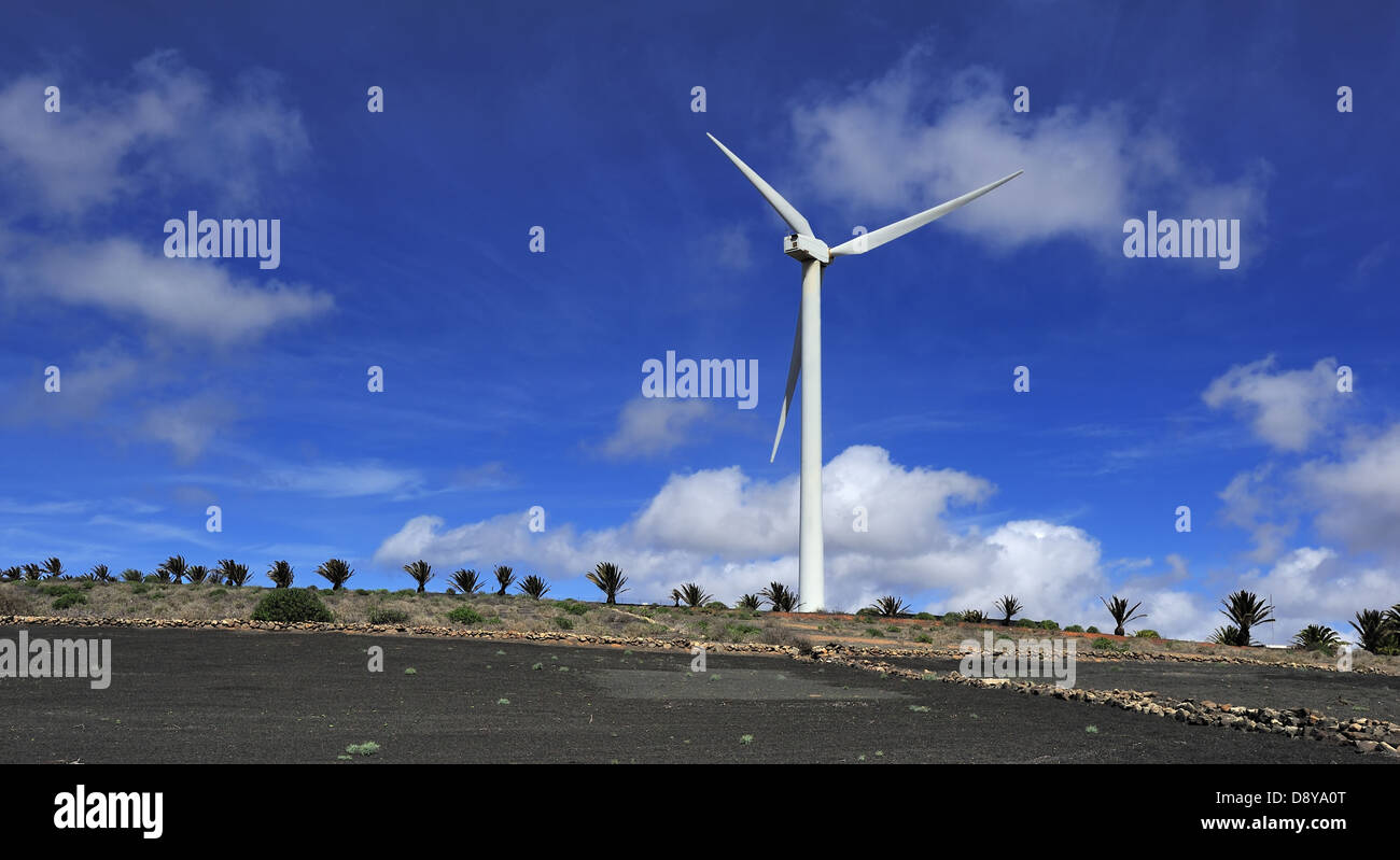 wind turbine staying in the shoulder of hill Stock Photo - Alamy