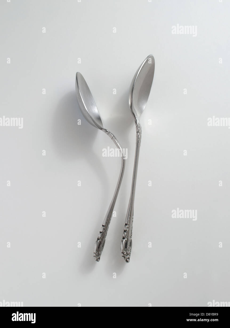 two side-by-side spoons Stock Photo - Alamy