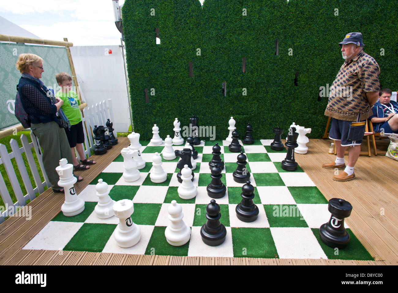 People playing on giant chess set at Hay Festival 2013 Hay on Wye Powys ...