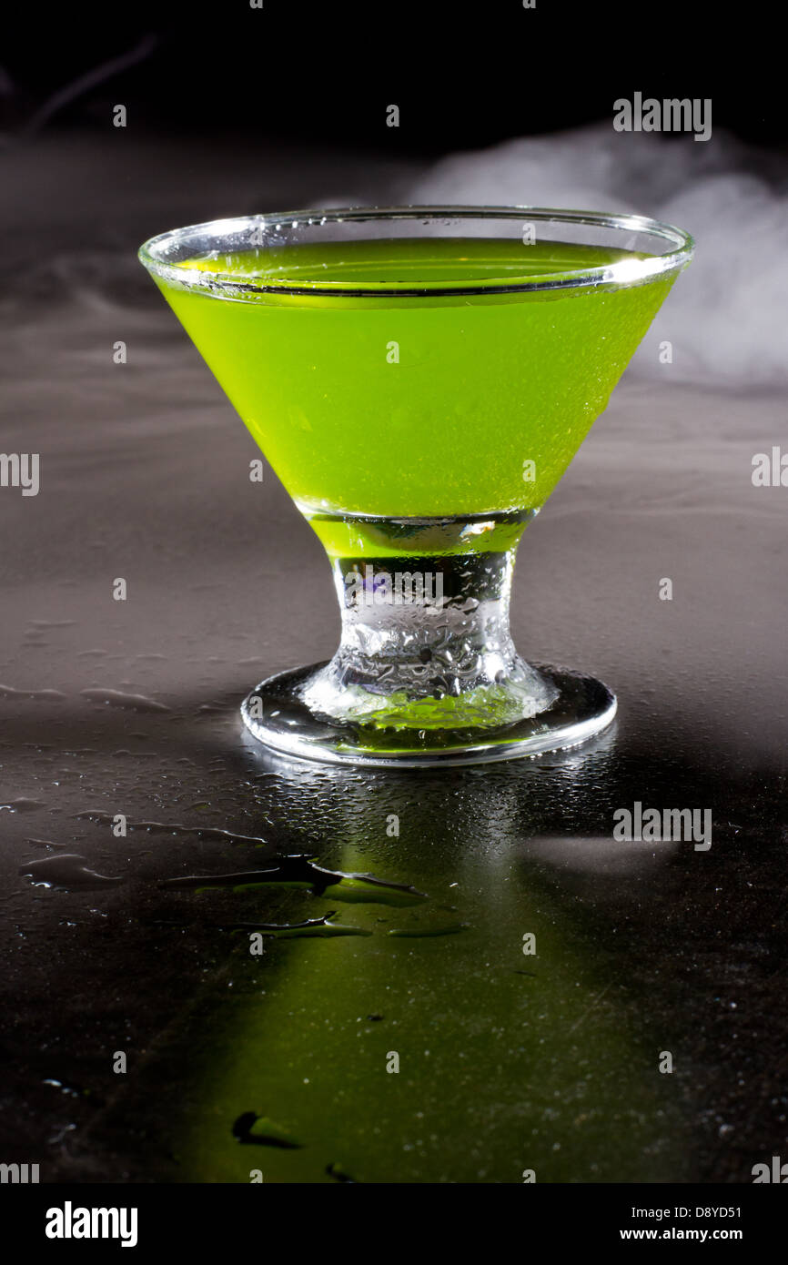 small bright green cocktail on a dark foggy dramatic bar Stock Photo ...