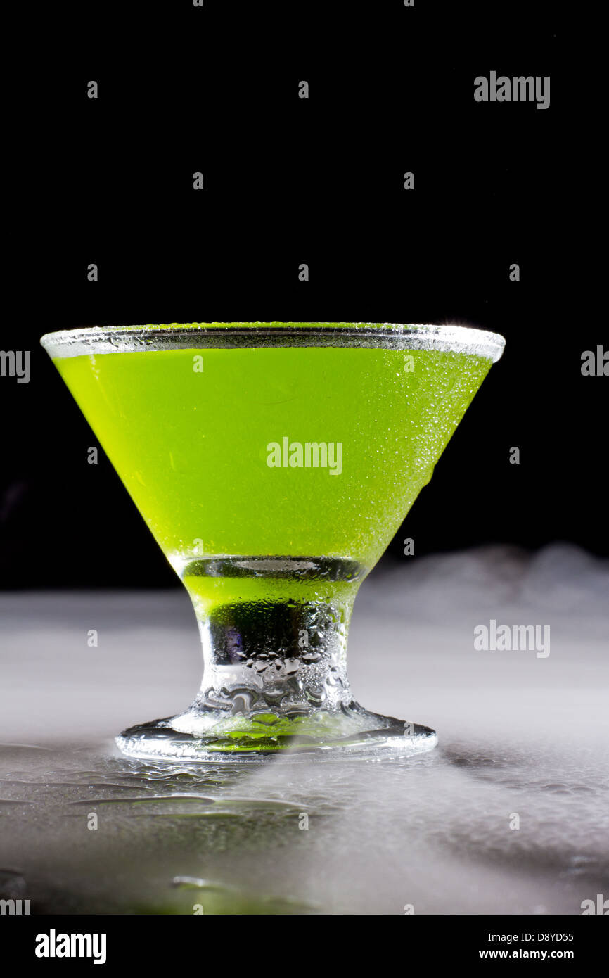 small bright green cocktail on a dark foggy dramatic bar Stock Photo ...