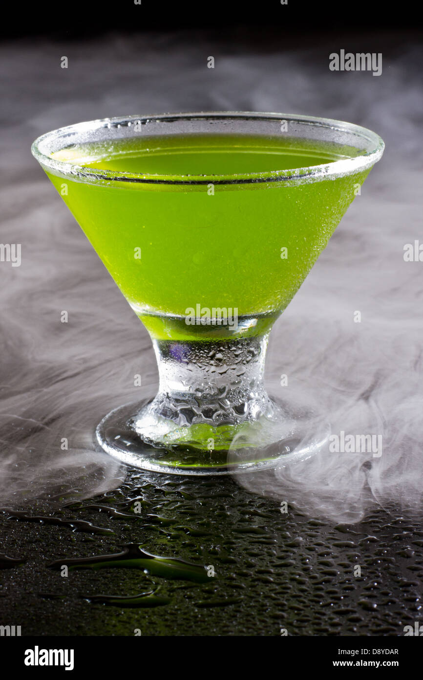 small bright green cocktail on a dark foggy dramatic bar Stock Photo ...