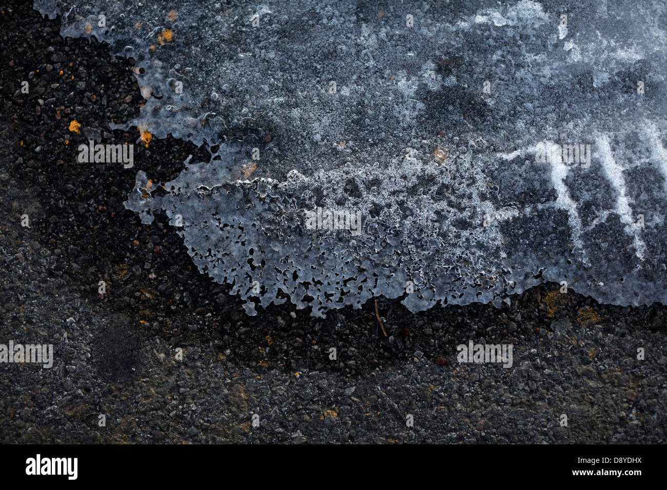 Melting ice on asphalt Stock Photo - Alamy