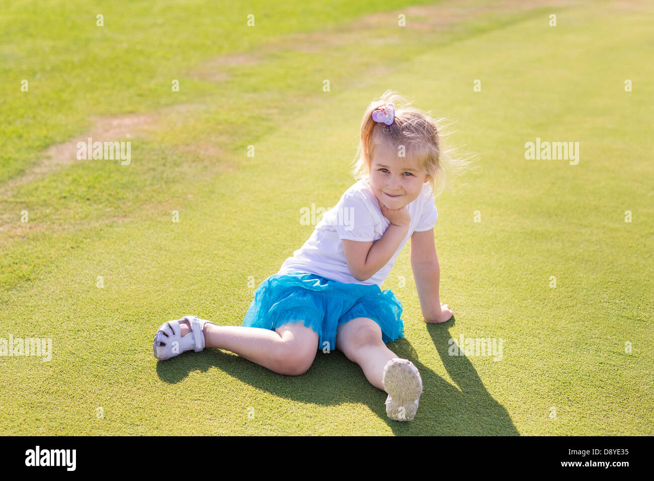 Cute little girl playing golf on a field outdoor Stock Photo - Alamy
