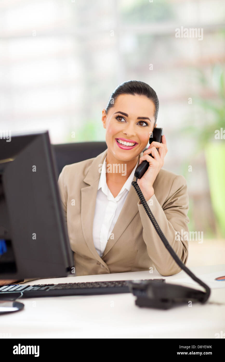 pretty business woman answering telephone in office Stock Photo - Alamy