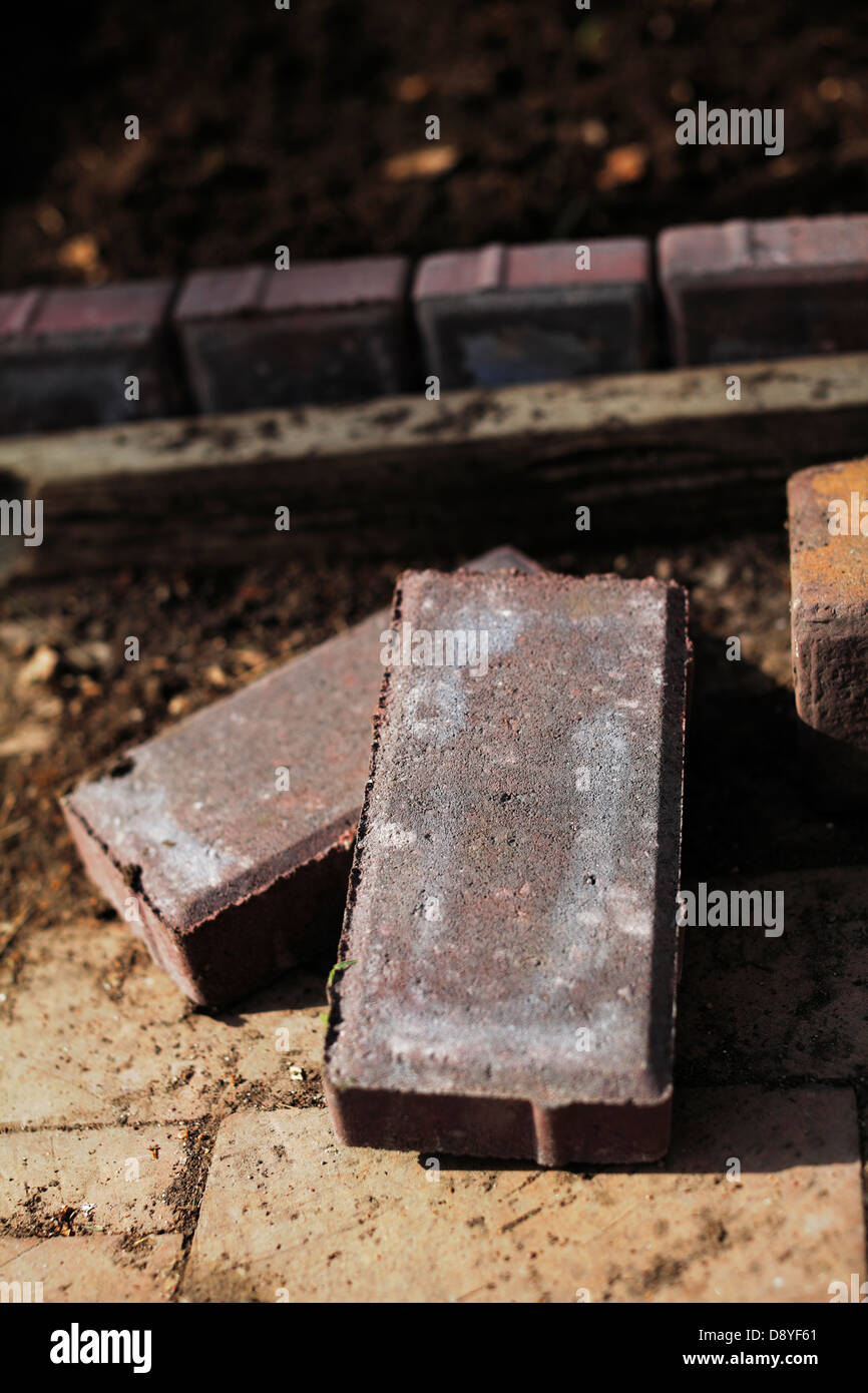 Two red brick-shaped pavers Stock Photo - Alamy