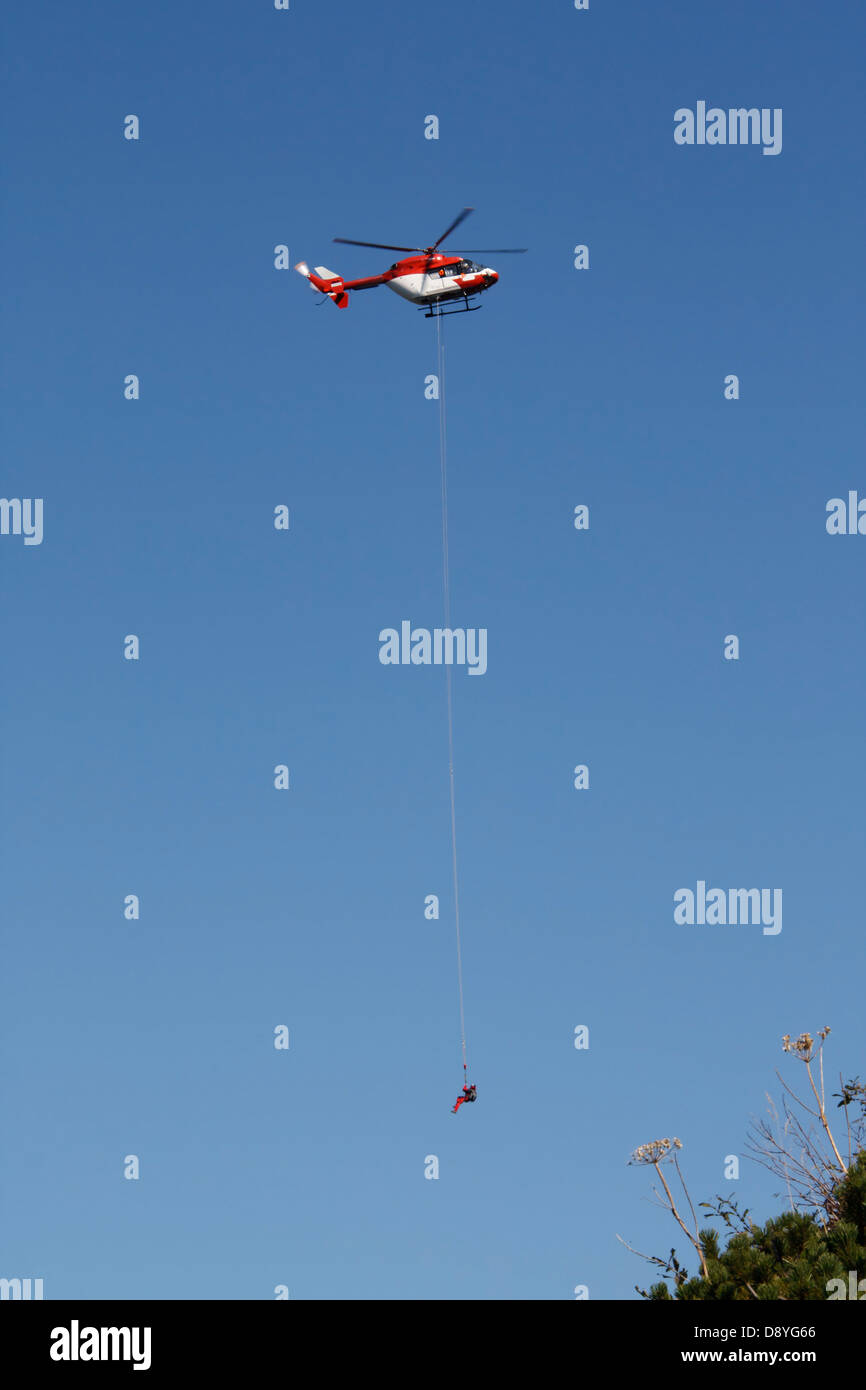 Rescue helicopter releasing a man on a rope Stock Photo - Alamy