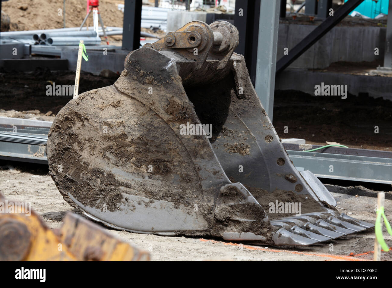 Excavator scoop bucket at job site Stock Photo - Alamy