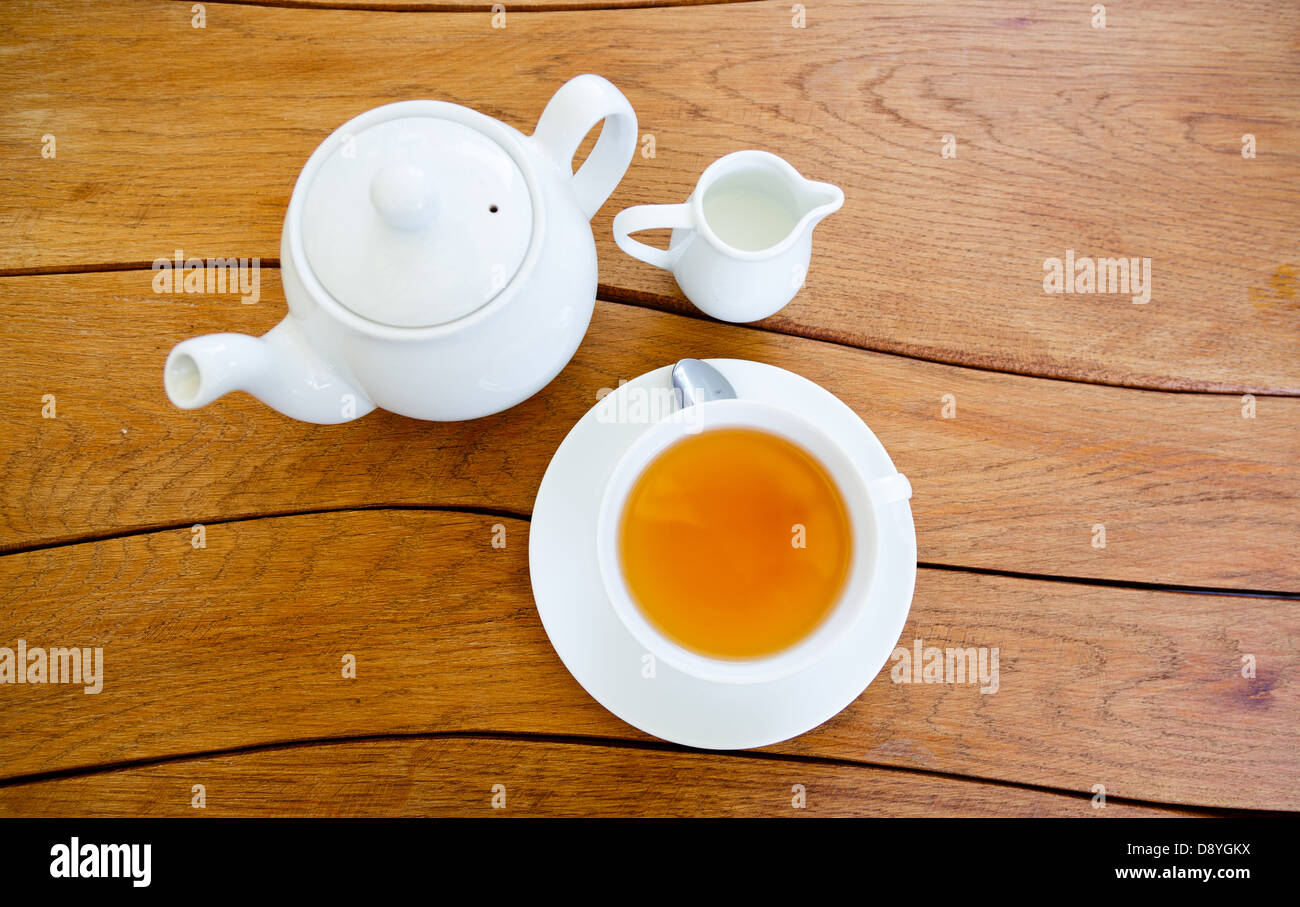 Cup of tea with tea pot and milk Stock Photo - Alamy