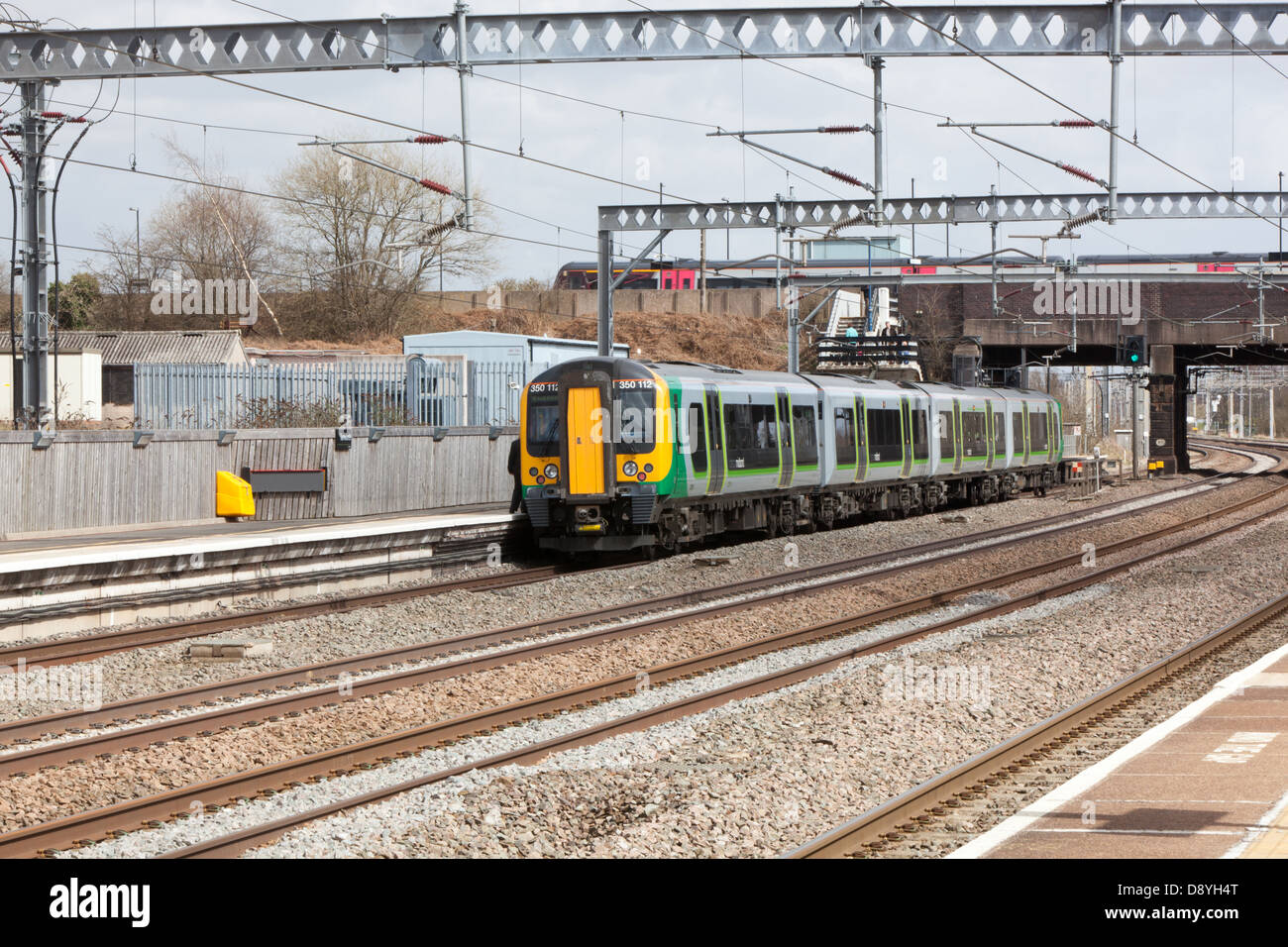 A London Midland train on West Coast Main Line at Tamworth. A Cross Country train in the ...