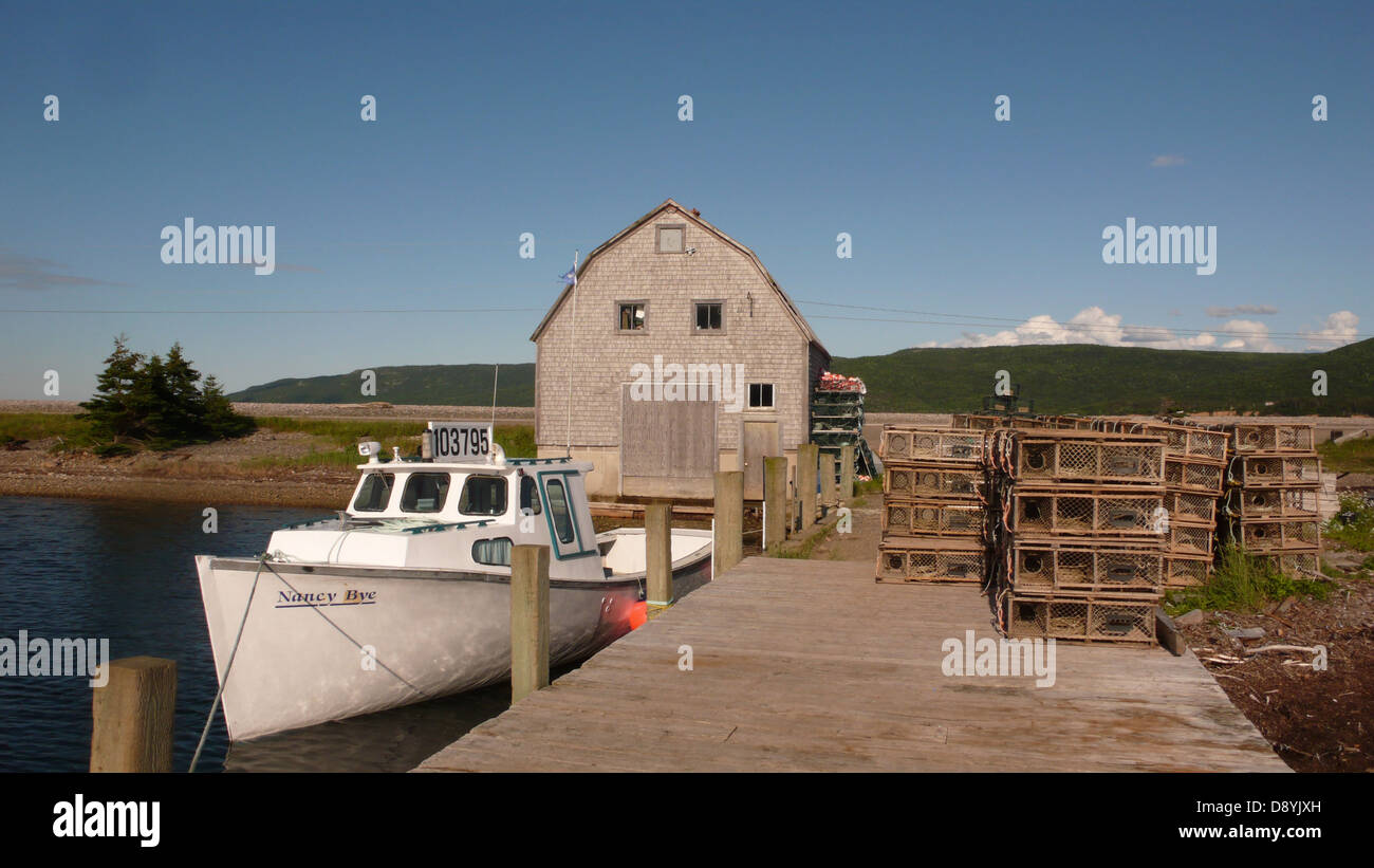Lobster traps placed upon a small wharf located on the Cabot Trail ...