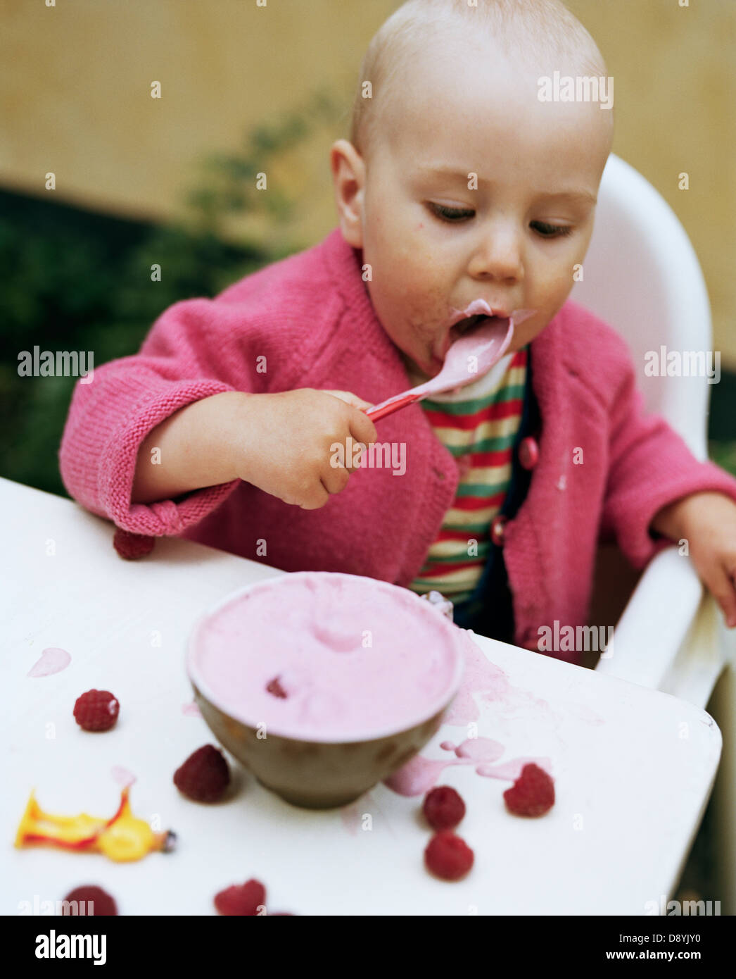 A child eating raspberry and yoghurt, Sweden Stock Photo - Alamy