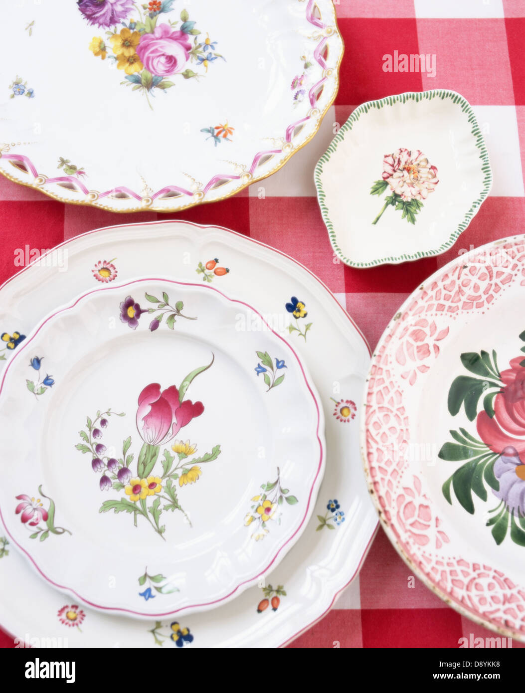 Floral patterned porcelain plates on checked table cloth Stock Photo ...