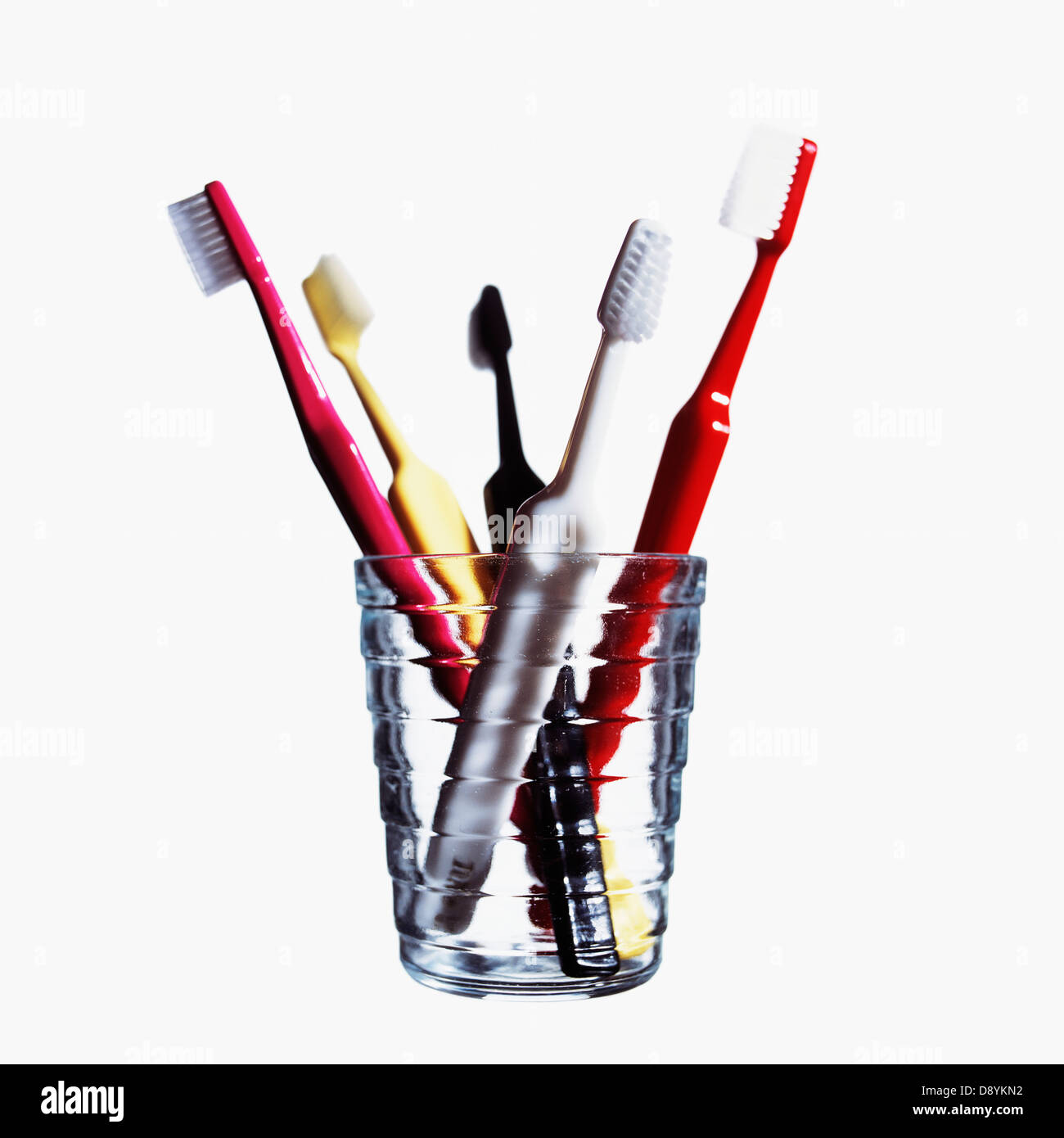 Studio close up of toothbrushes in glass Stock Photo - Alamy
