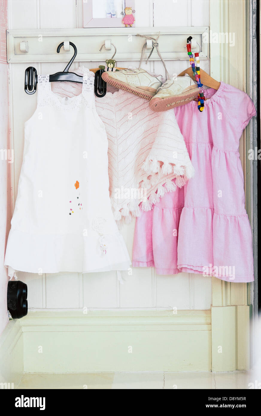 Children´s clothes hanging on a wall Stock Photo - Alamy