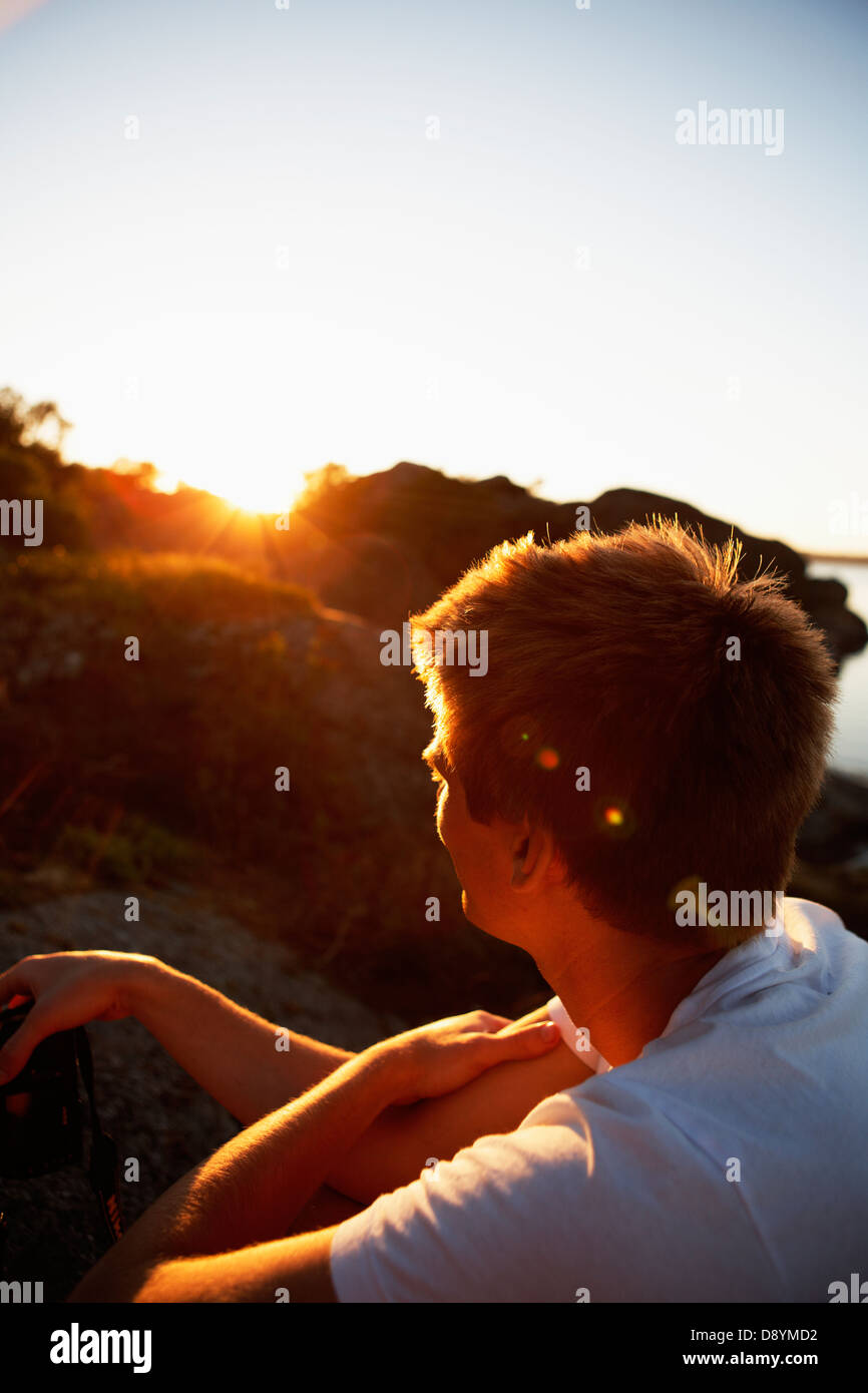 A young man looking at the sunset, Sweden Stock Photo - Alamy