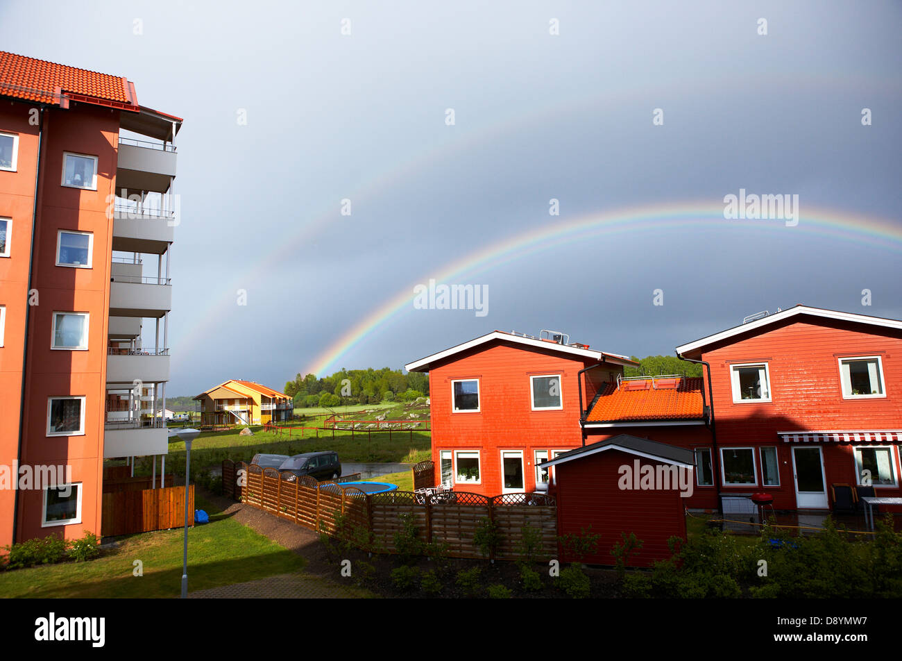 Rainbow over houses, Sweden Stock Photo - Alamy