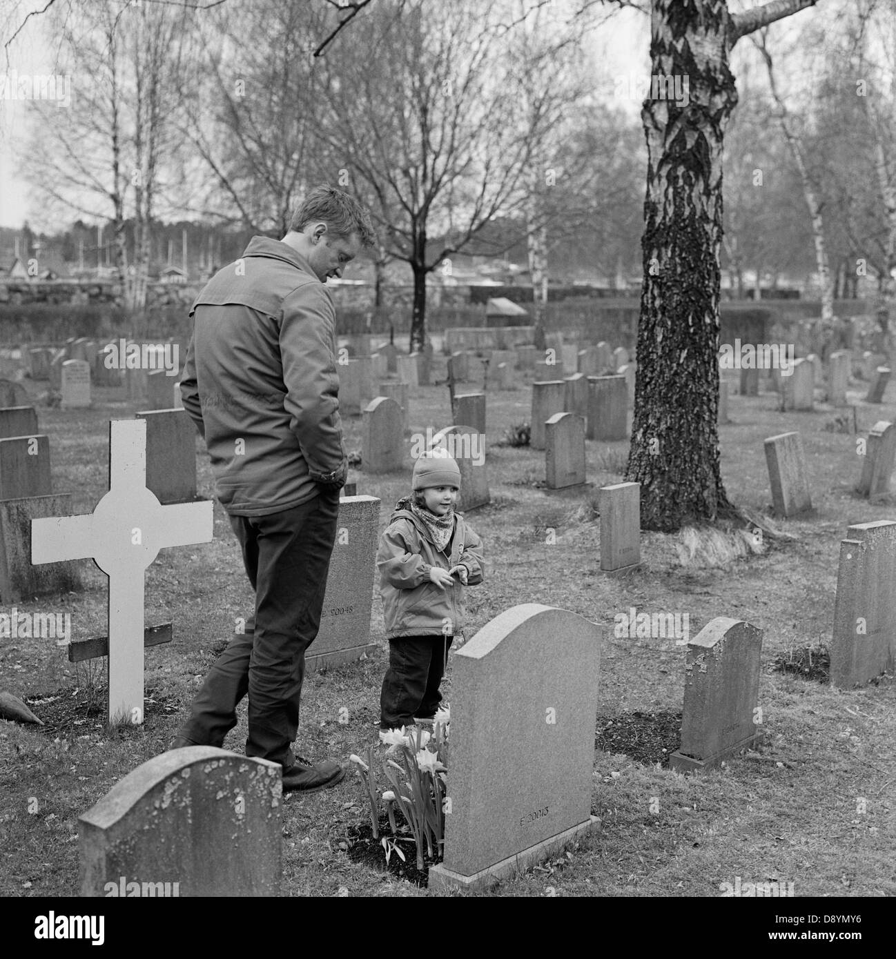 Father with daughter on graveyard Stock Photo - Alamy