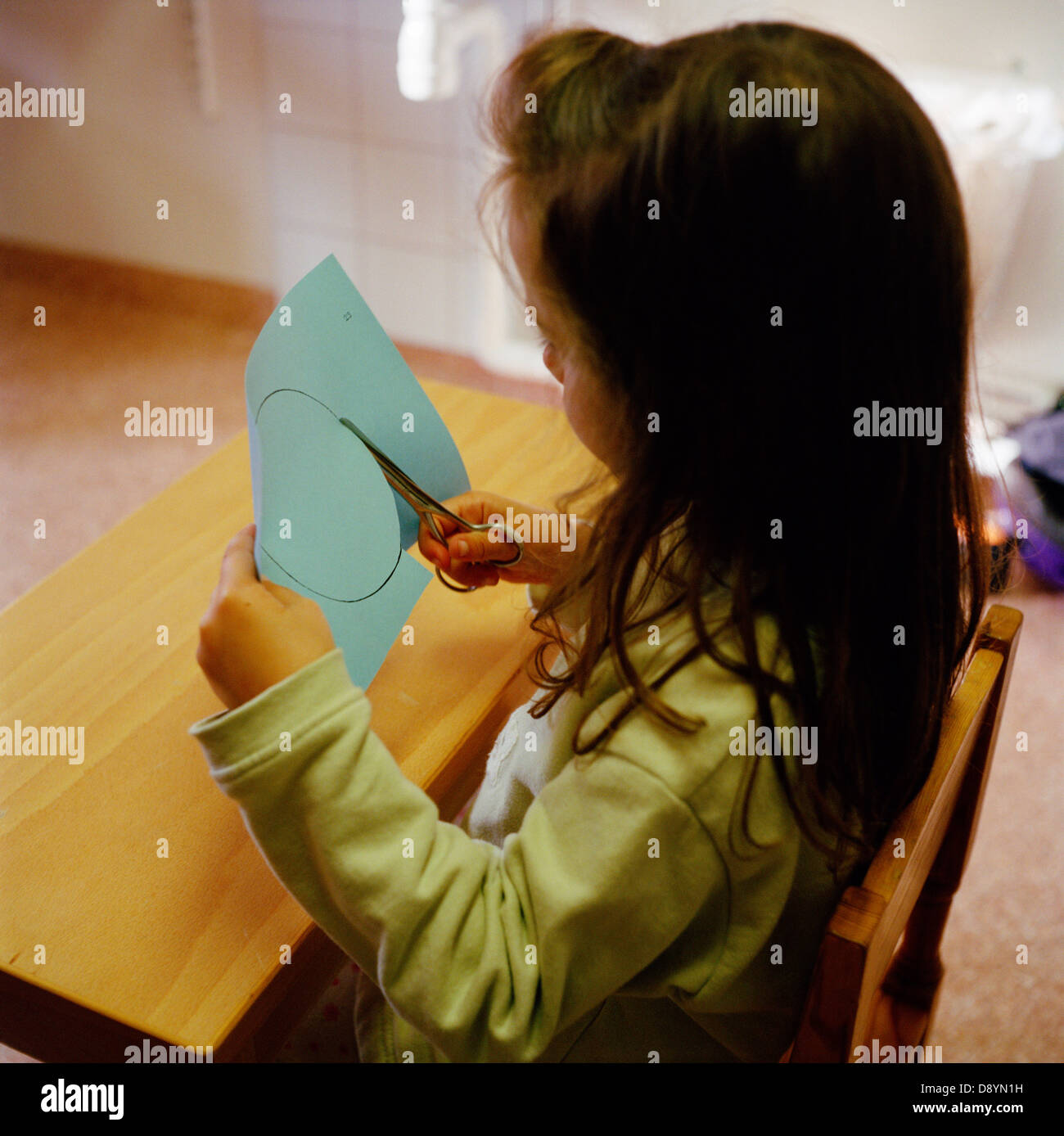 Girl cutting paper Stock Photo - Alamy