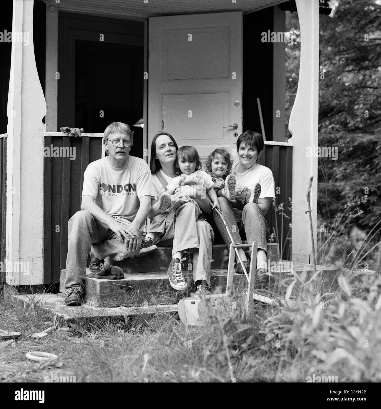 Happy family sitting together white Black and White Stock Photos ...
