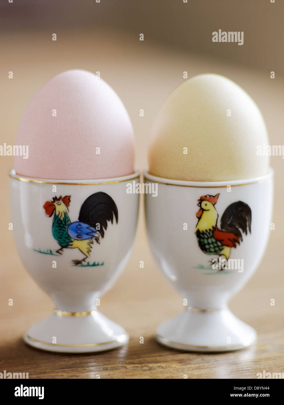 Two colored eggs in egg cups Stock Photo - Alamy
