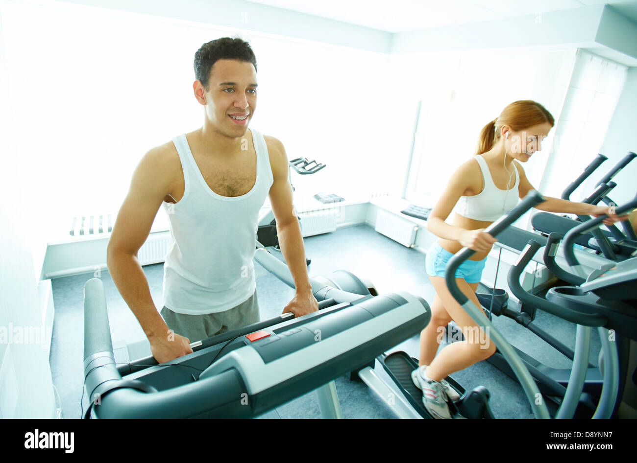 Portrait of pretty girl training on special sport equipment in gym ...