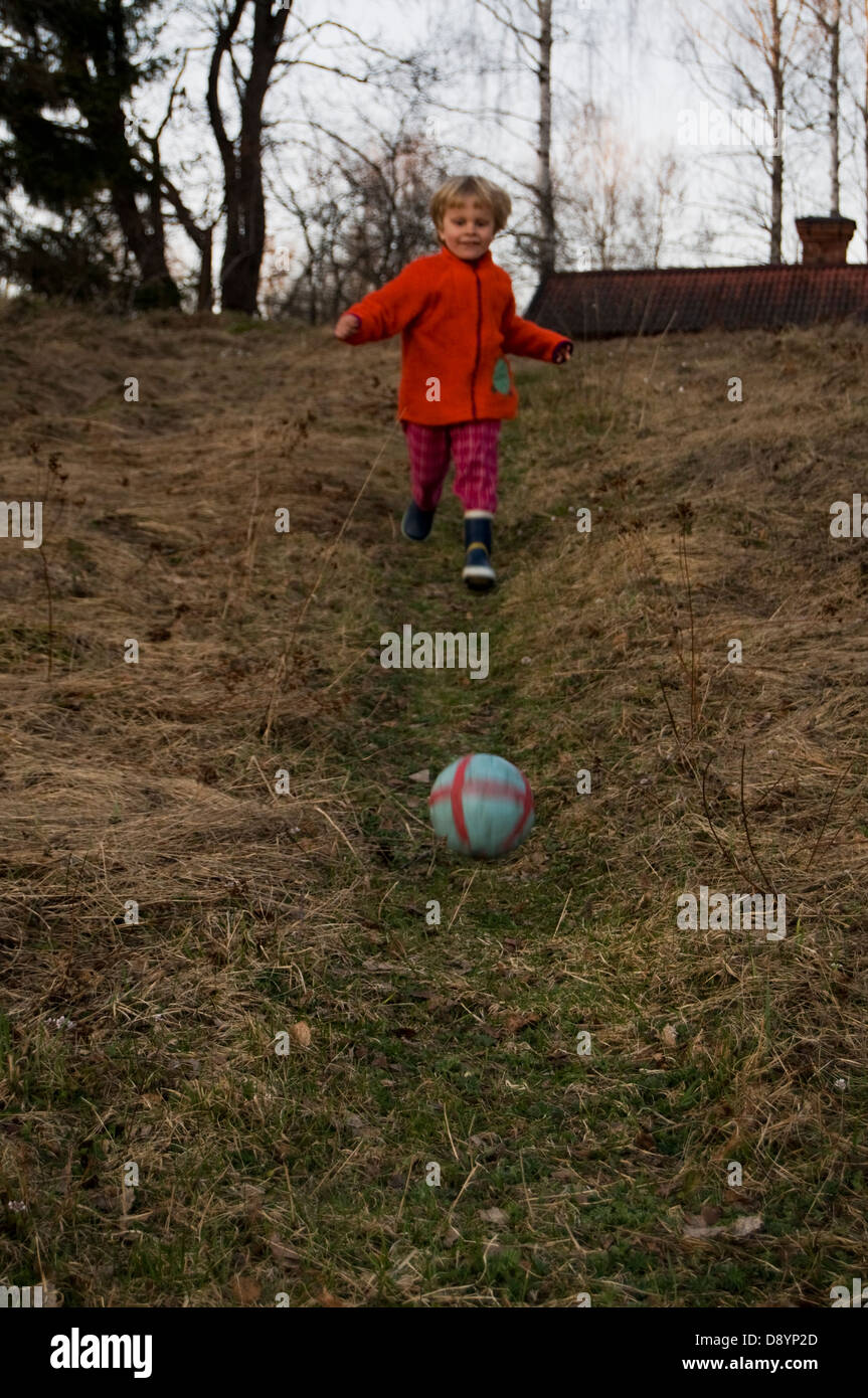 Small boy running after ball Stock Photo - Alamy