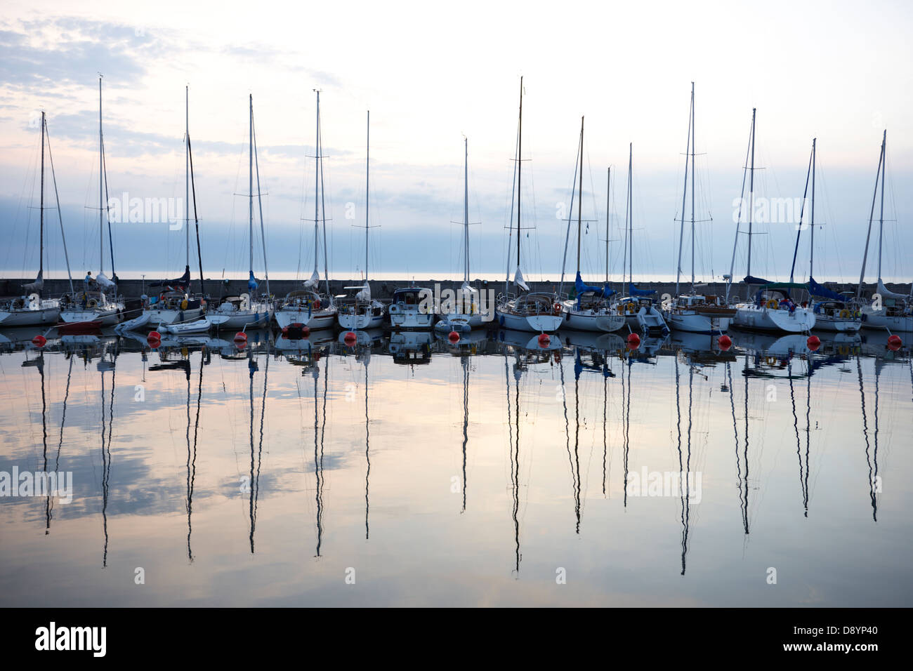 View of sailing boats with reflection in water Stock Photo - Alamy