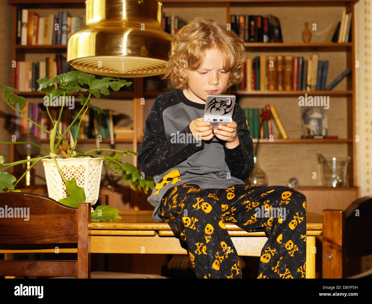 A boy playing Gameboy Stock Photo - Alamy