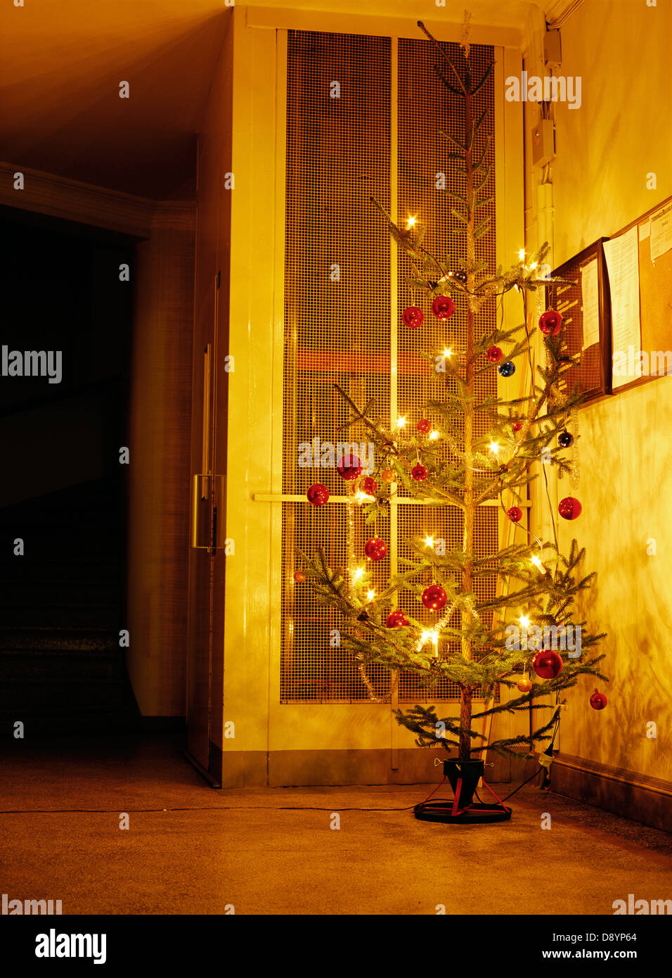 A Christmas tree with lit lights Stock Photo - Alamy