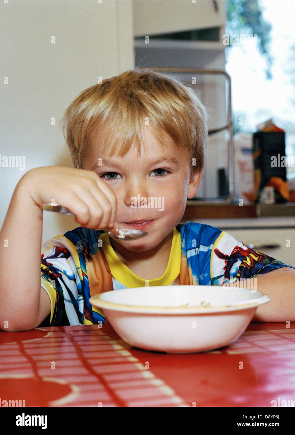 A boy eating breakfast Stock Photo - Alamy