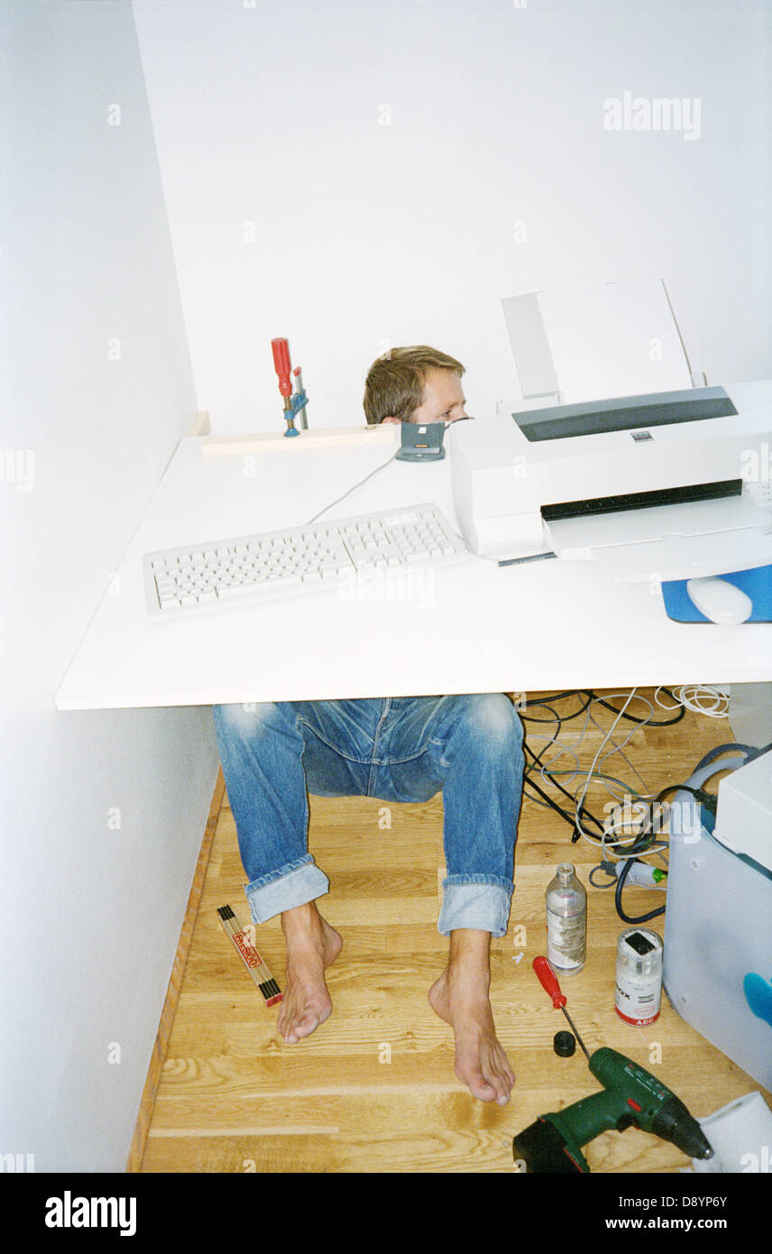 A man under a table Stock Photo - Alamy